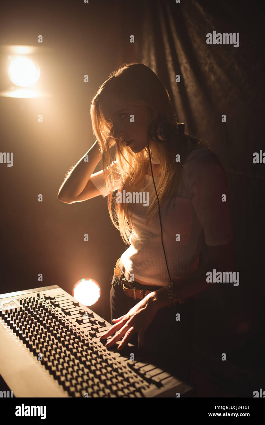 Confident female DJ playing music in illuminated nightclub Stock Photo ...