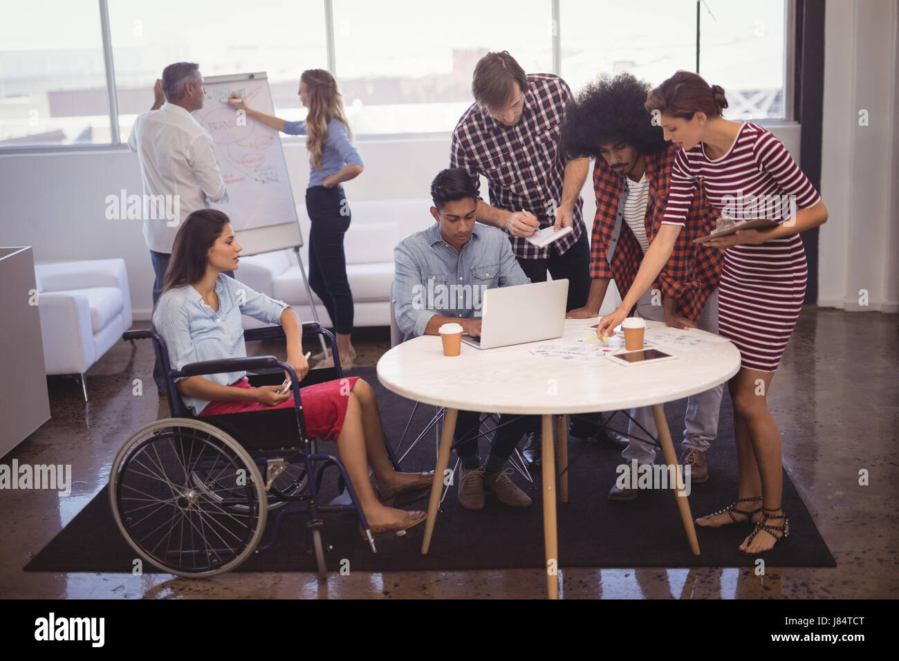 Handicap business people with colleagues planning in creative office ...