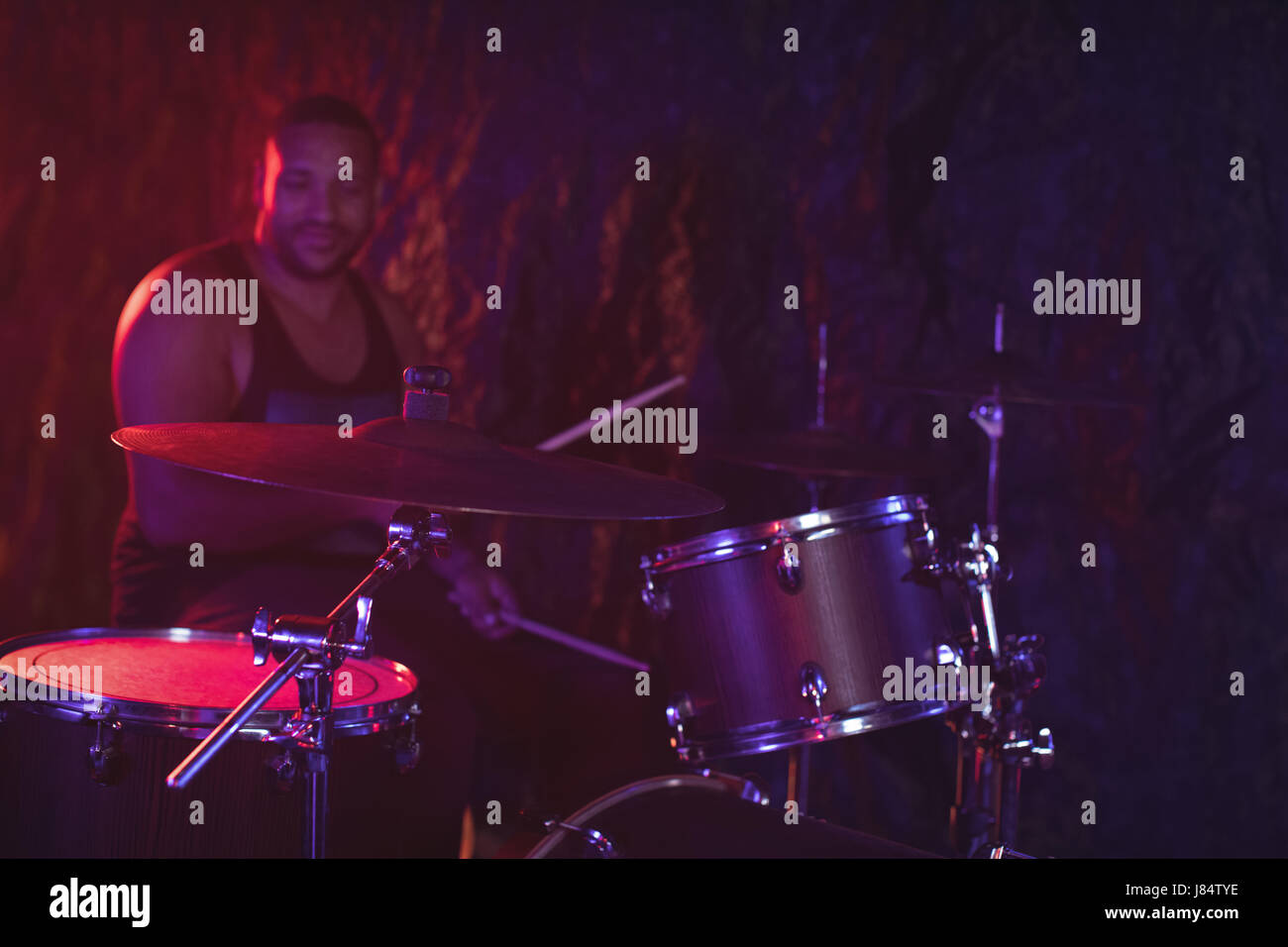 Smiling drummer performing at music concert Stock Photo - Alamy