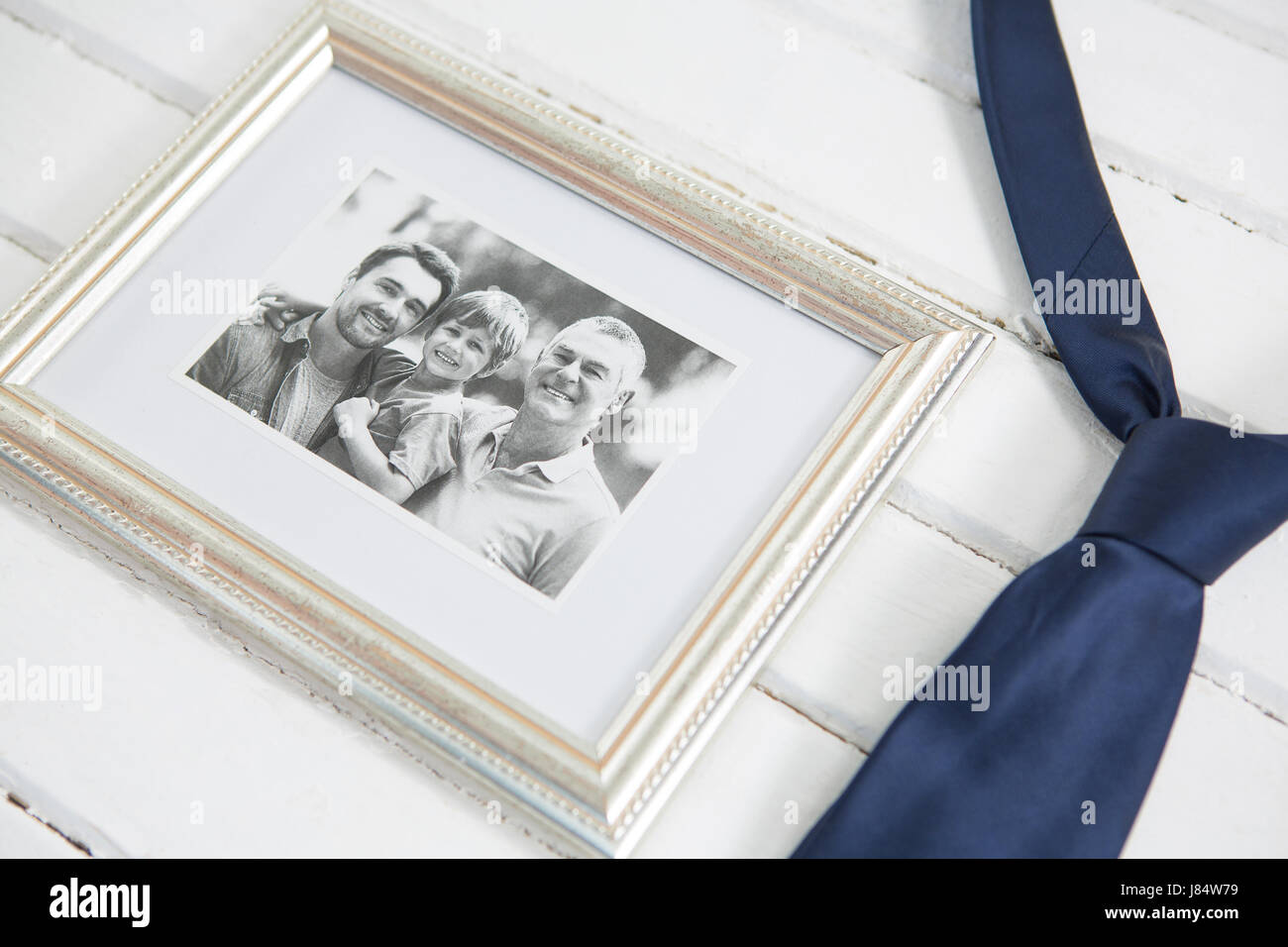 High angle view of photo frame with necktie on wooden table Stock Photo ...