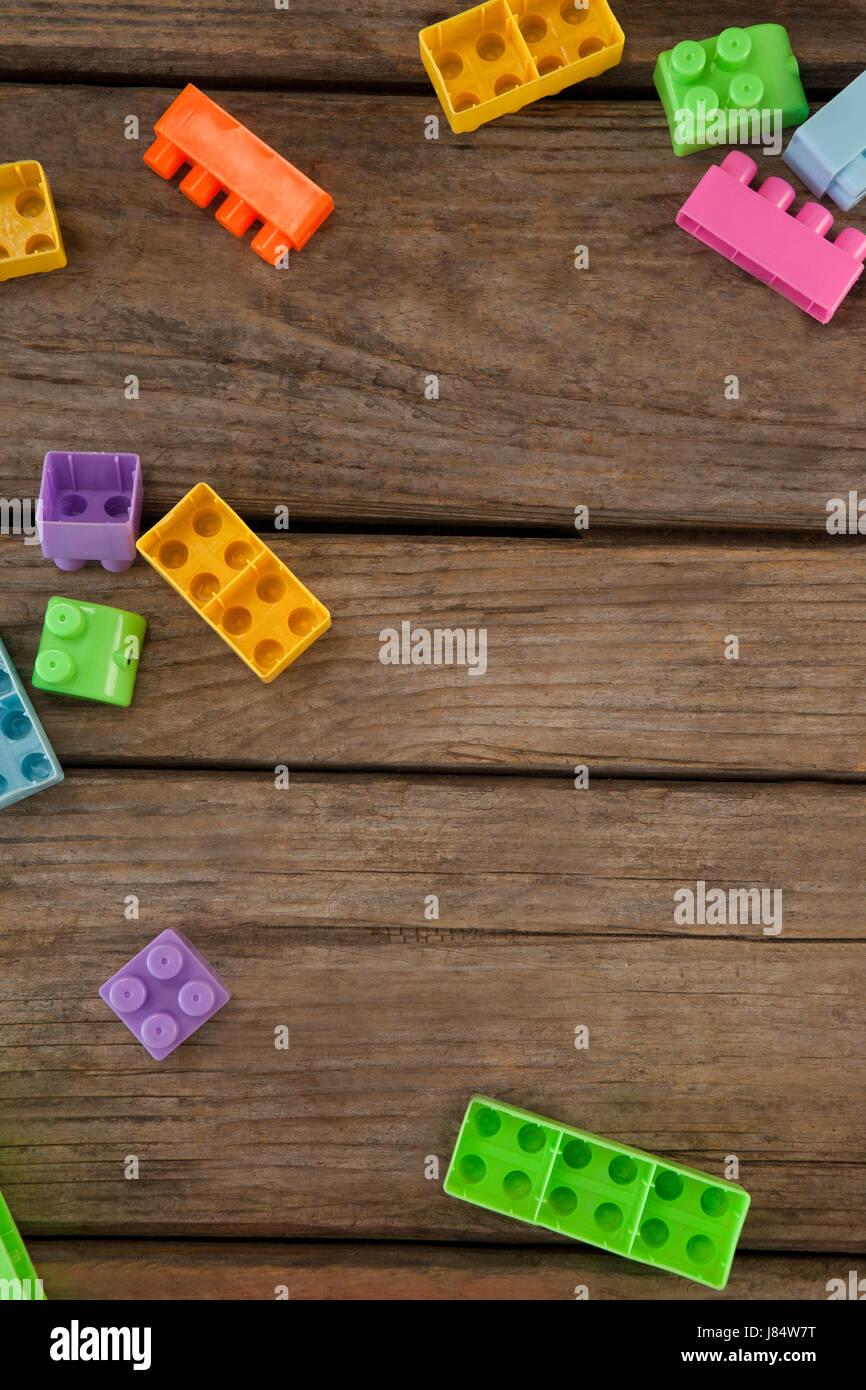 Overhead view of plastic toy blocks on wooden table Stock Photo - Alamy