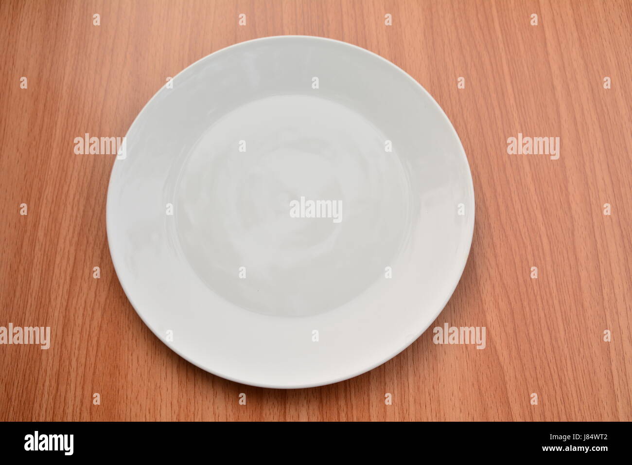 Empty plate on wood table background. View from above Stock Photo - Alamy