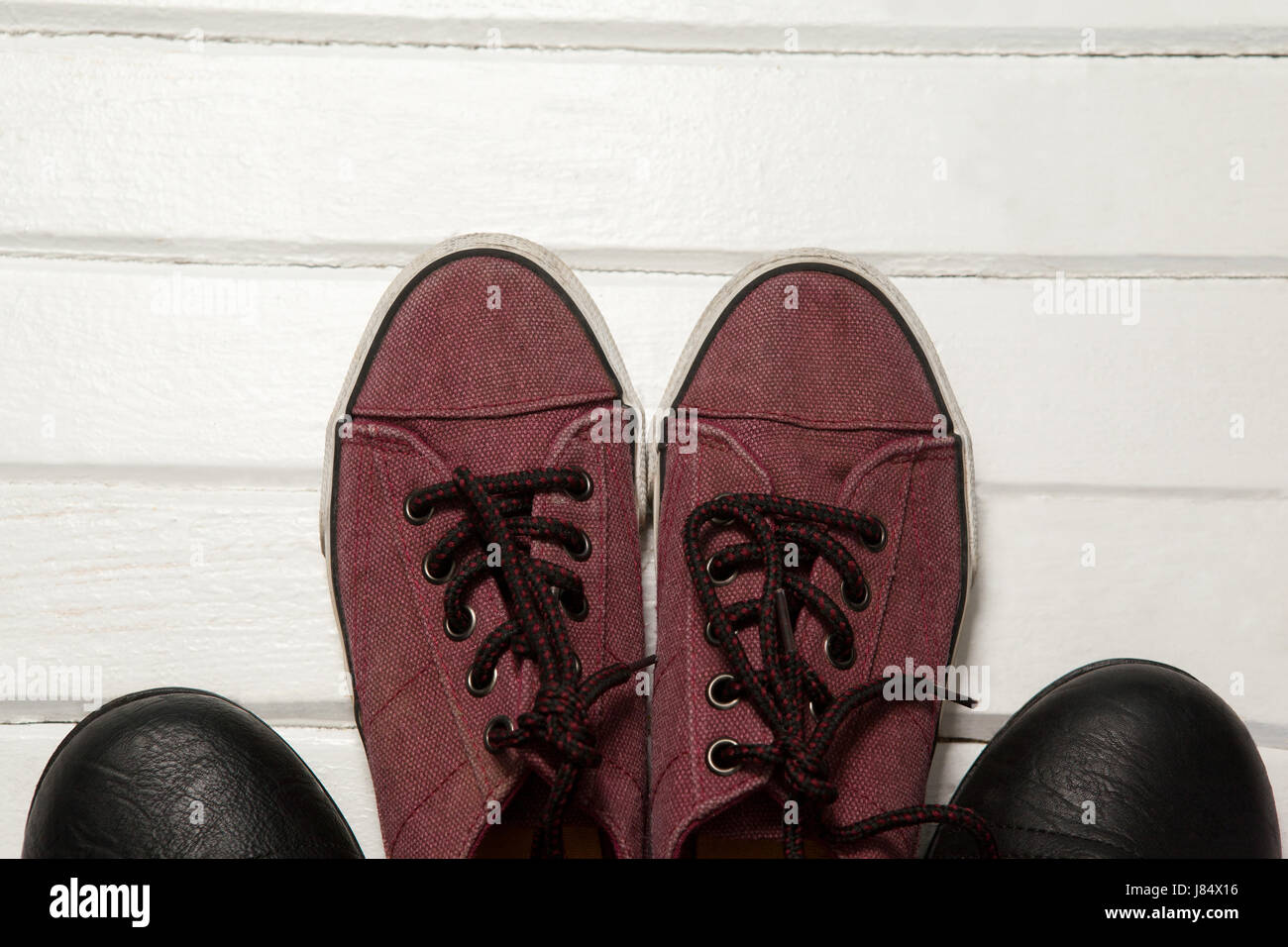 Overhead view of loafers and shoes on white wooden floor Stock Photo ...