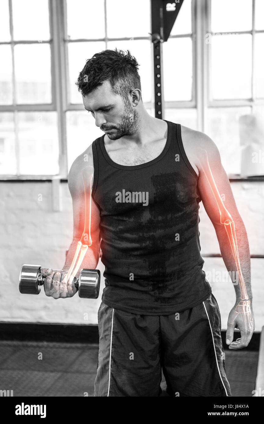 Digital composite of highlighted arm of strong man lifting weights at ...