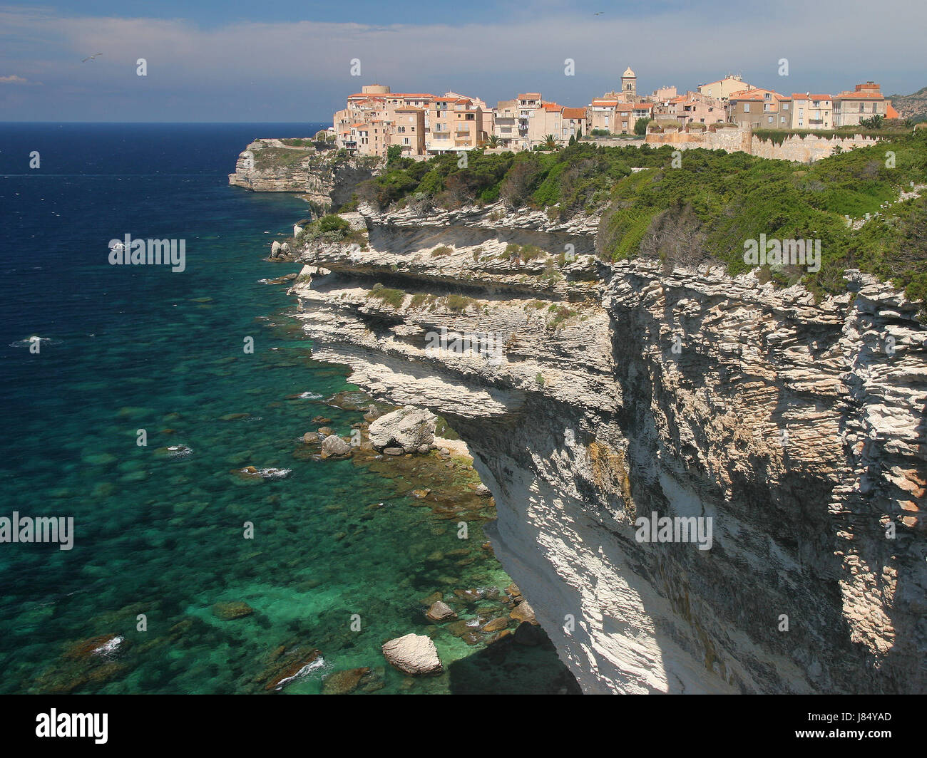 city town steep coast corsica limestone overhang salt water sea ocean ...