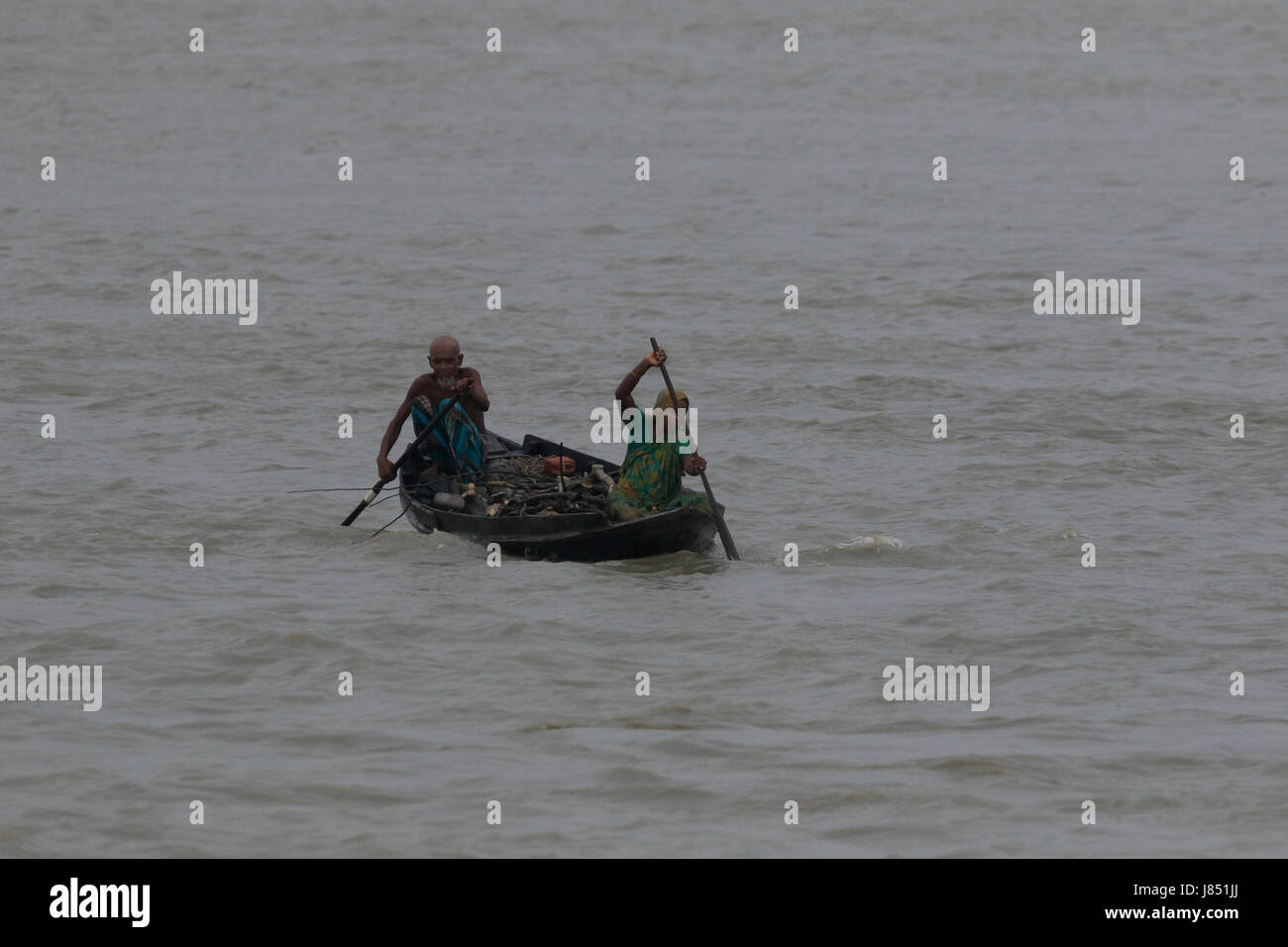 Old man rowing boat hi-res stock photography and images - Alamy
