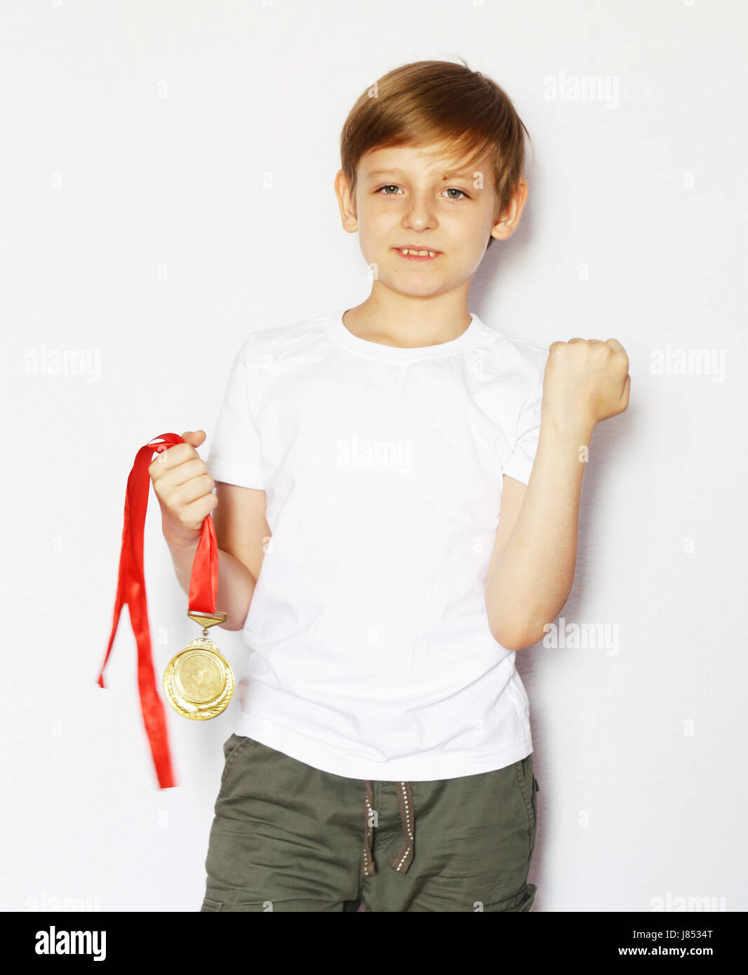 Cute blonde boy with gold medal winner Stock Photo - Alamy