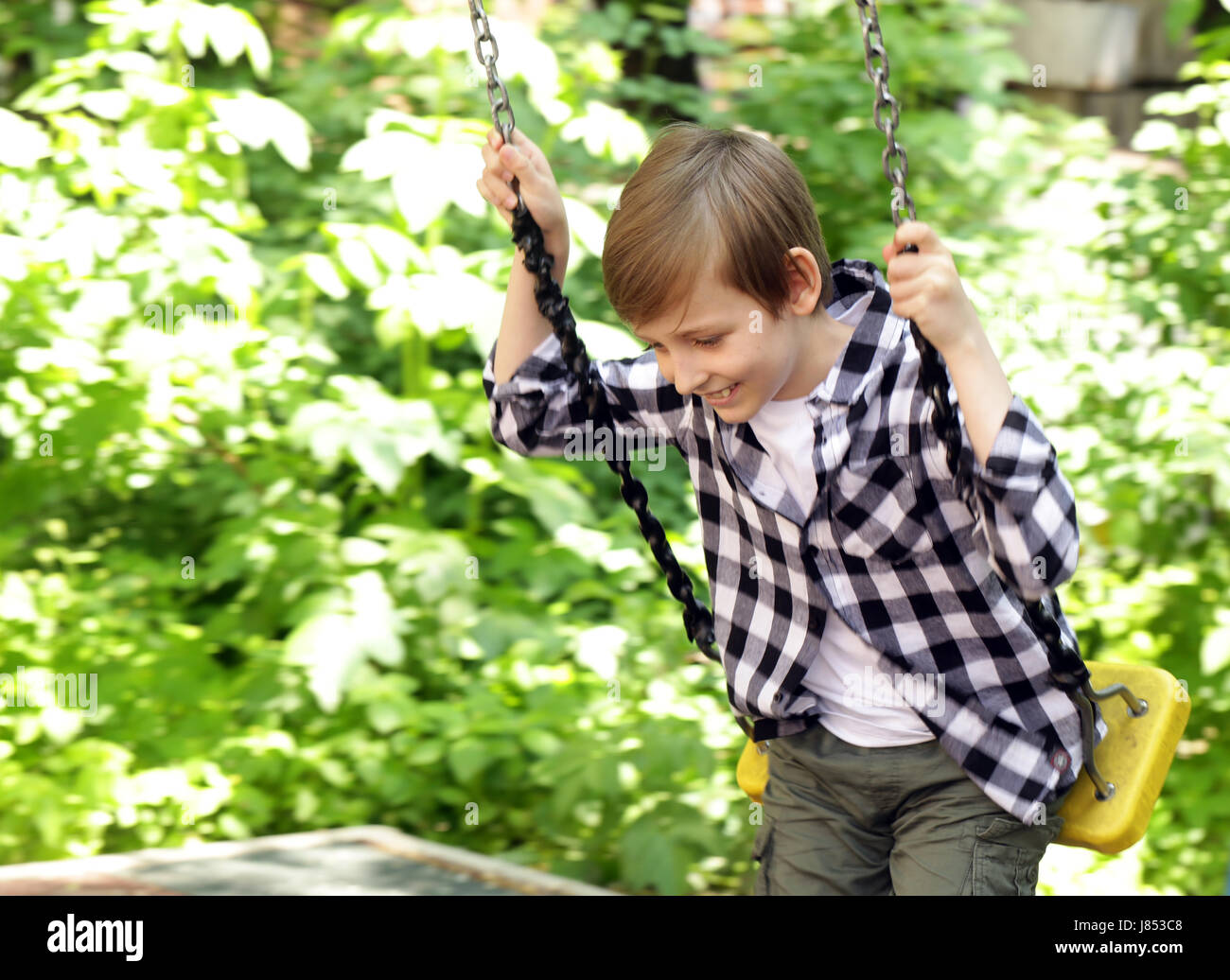 Boy playing in the playground in the park Stock Photo - Alamy