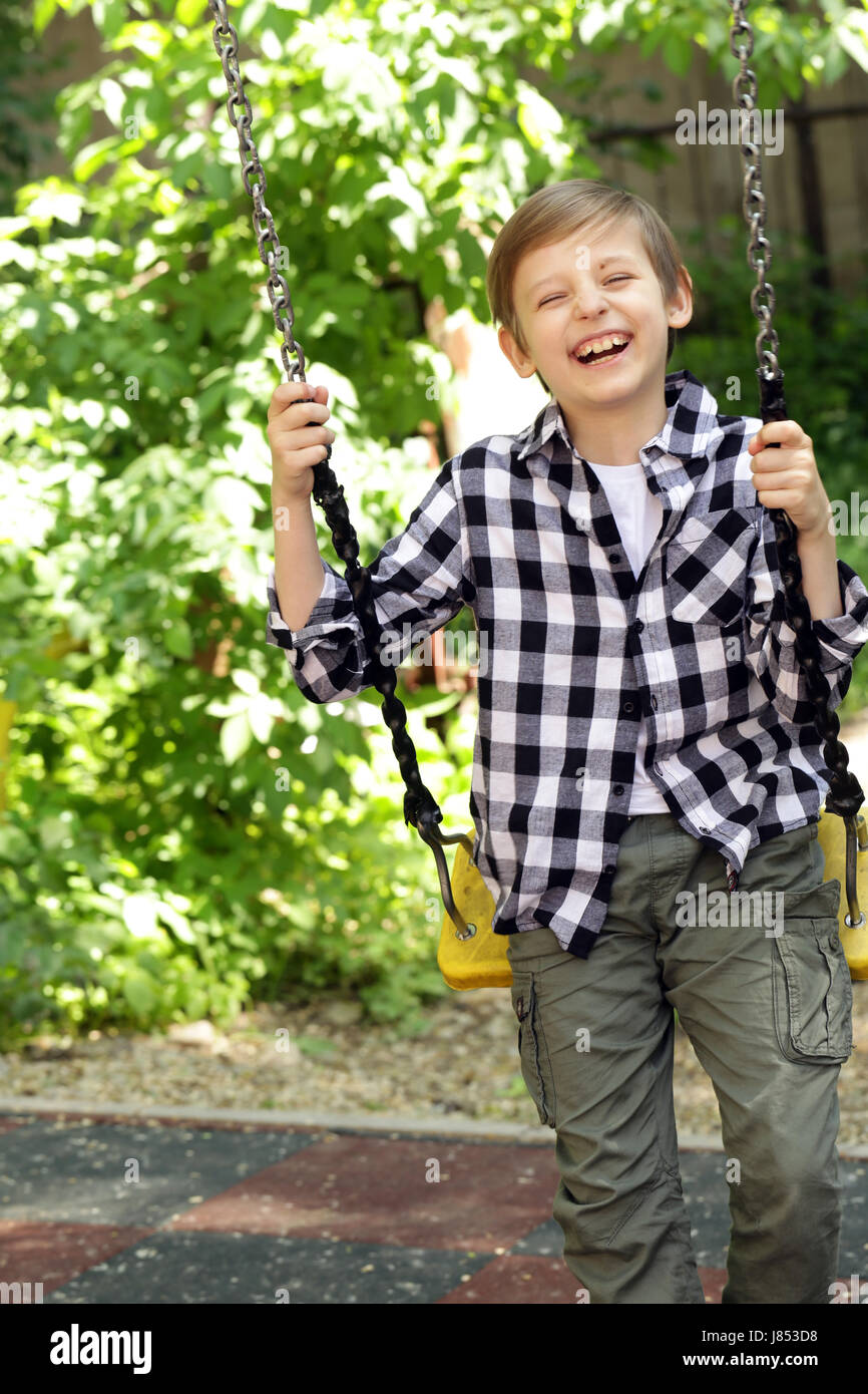 Boy playing in the playground in the park Stock Photo - Alamy