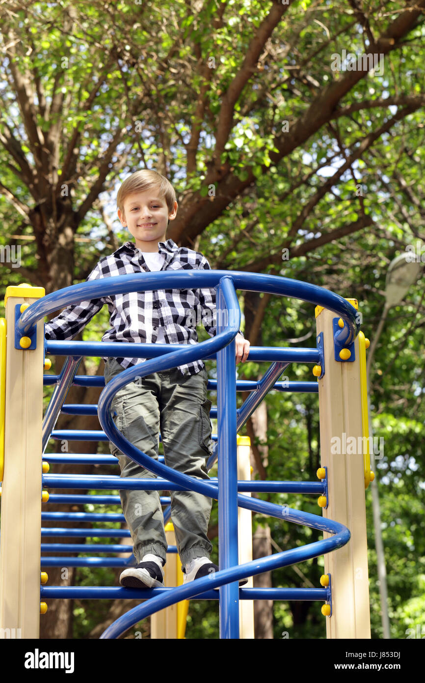 Boy playing in the playground in the park Stock Photo - Alamy