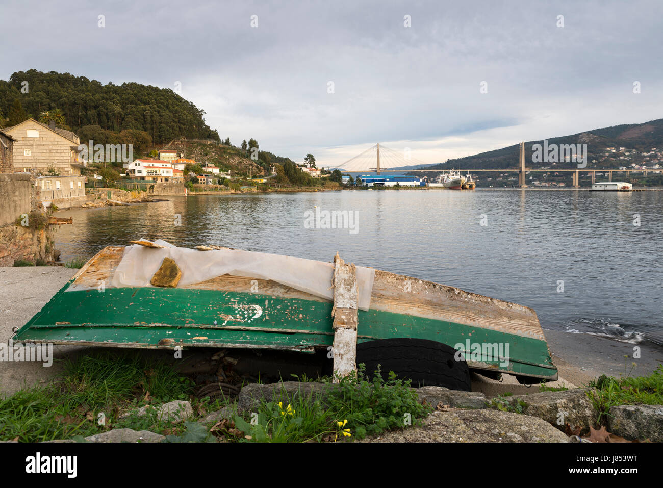 Old fishing boat beached in the Vigo estuary, Galicia, Spain. At the ...