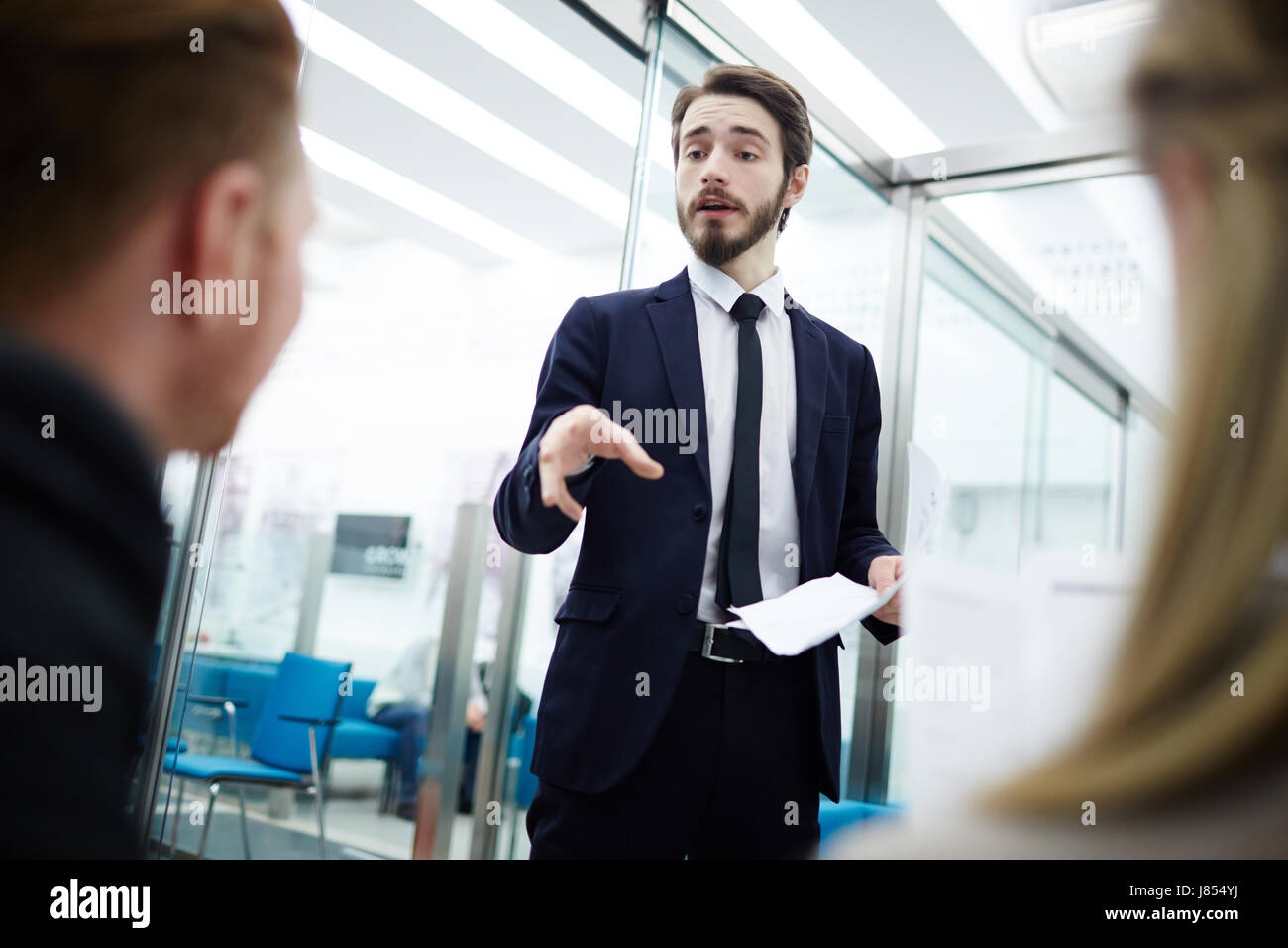 Expert in economics explaining colleagues his methods of work Stock ...