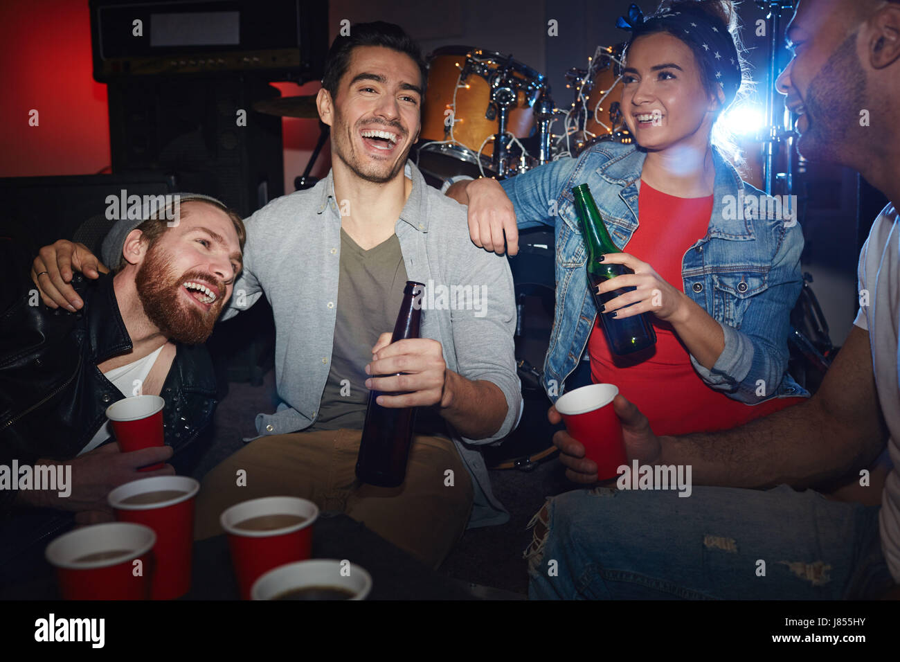 Ecstatic friends with beer having fun in night club Stock Photo - Alamy