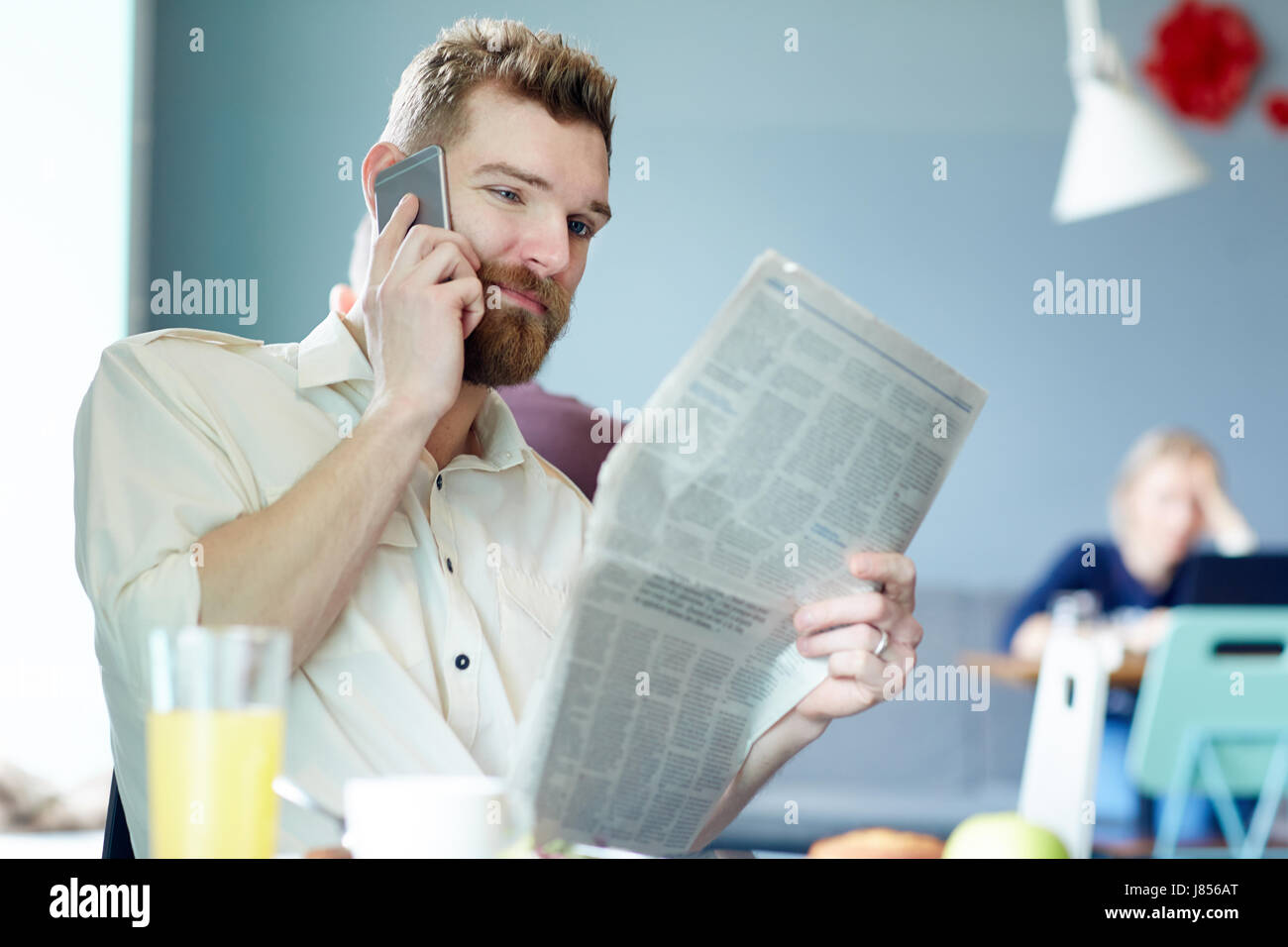 Portrait of modern handsome man in casual shirt speaking by smartphone ...