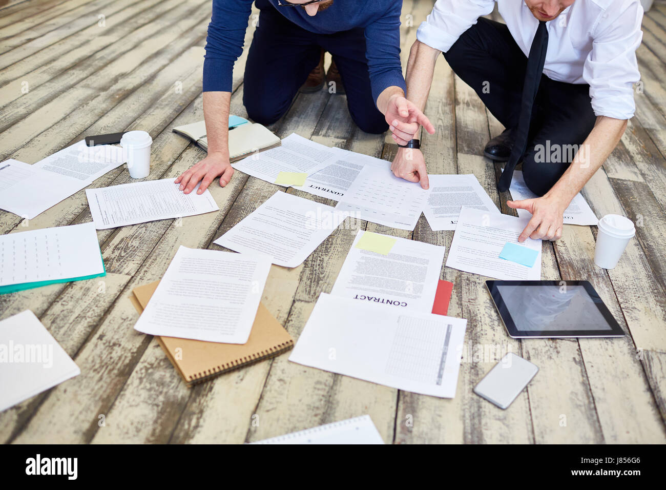 Business colleagues analyzing documents on hi-res stock photography and ...