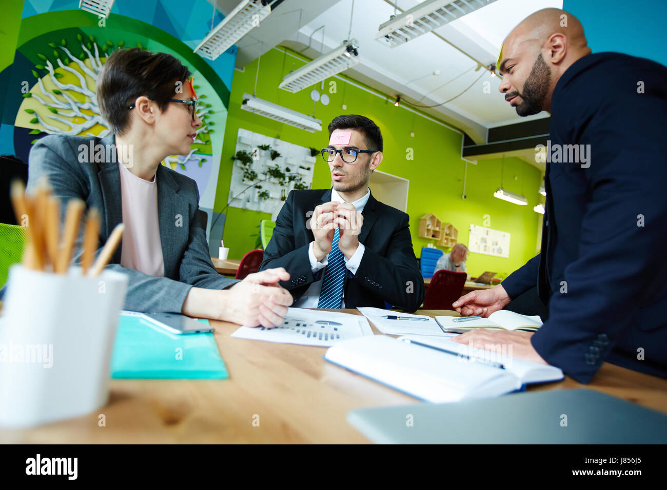 Group of contemporary business people trying to guess who is who in ...