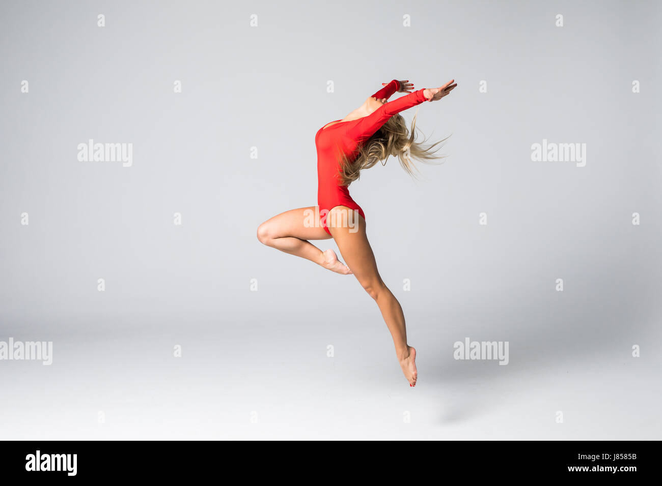young beautiful dancer posing on a studio background Stock Photo - Alamy