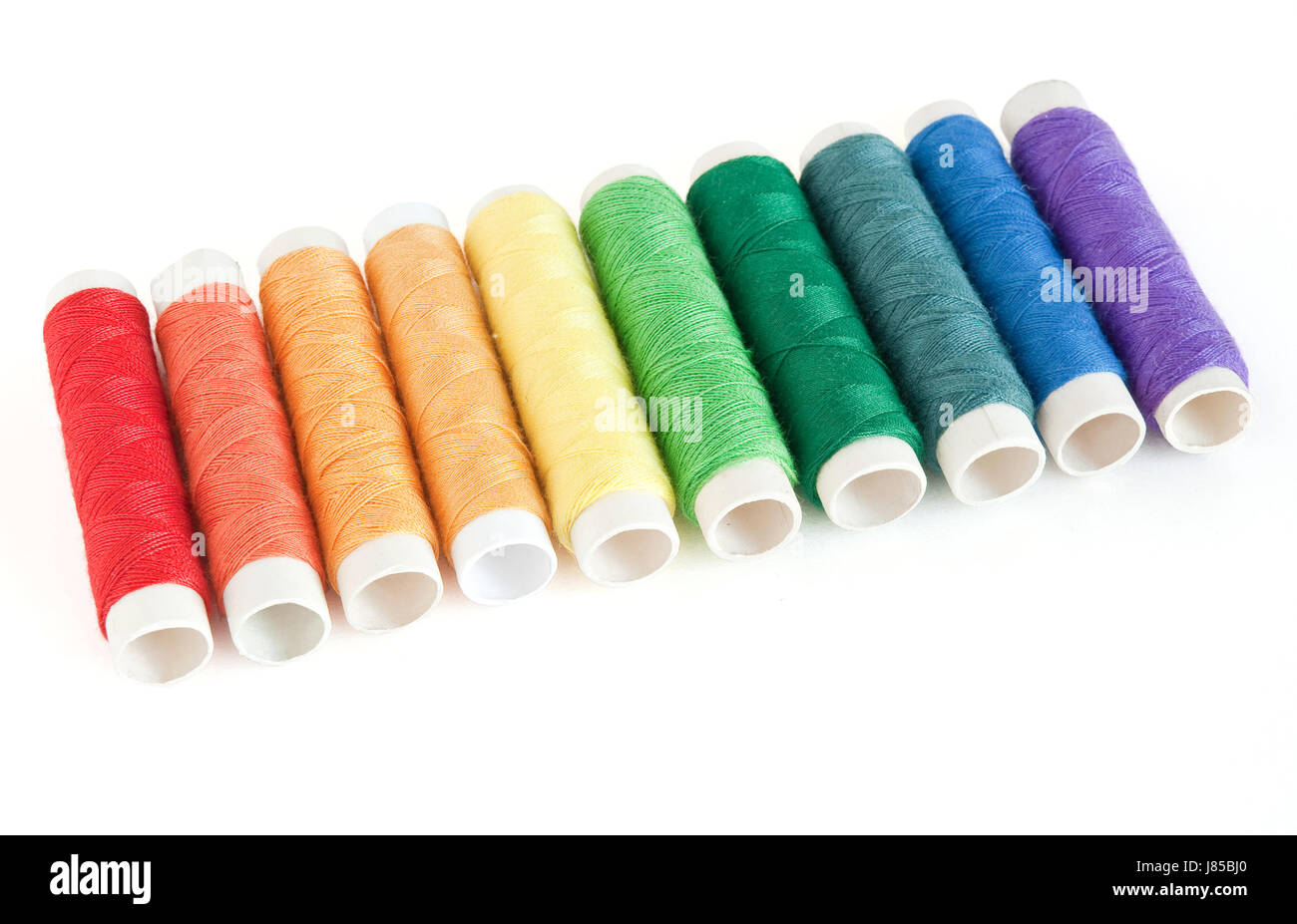 tool object isolated thread rainbow textile spool colorful close blue ...