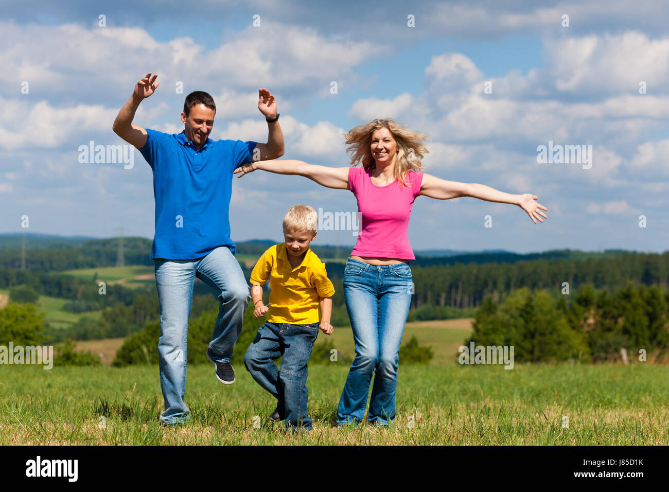 family playing catch in the meadow Stock Photo - Alamy