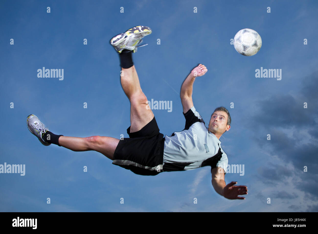 sport sports ball sport soccer player footballers falling overhead kick soccer Stock Photo - Alamy