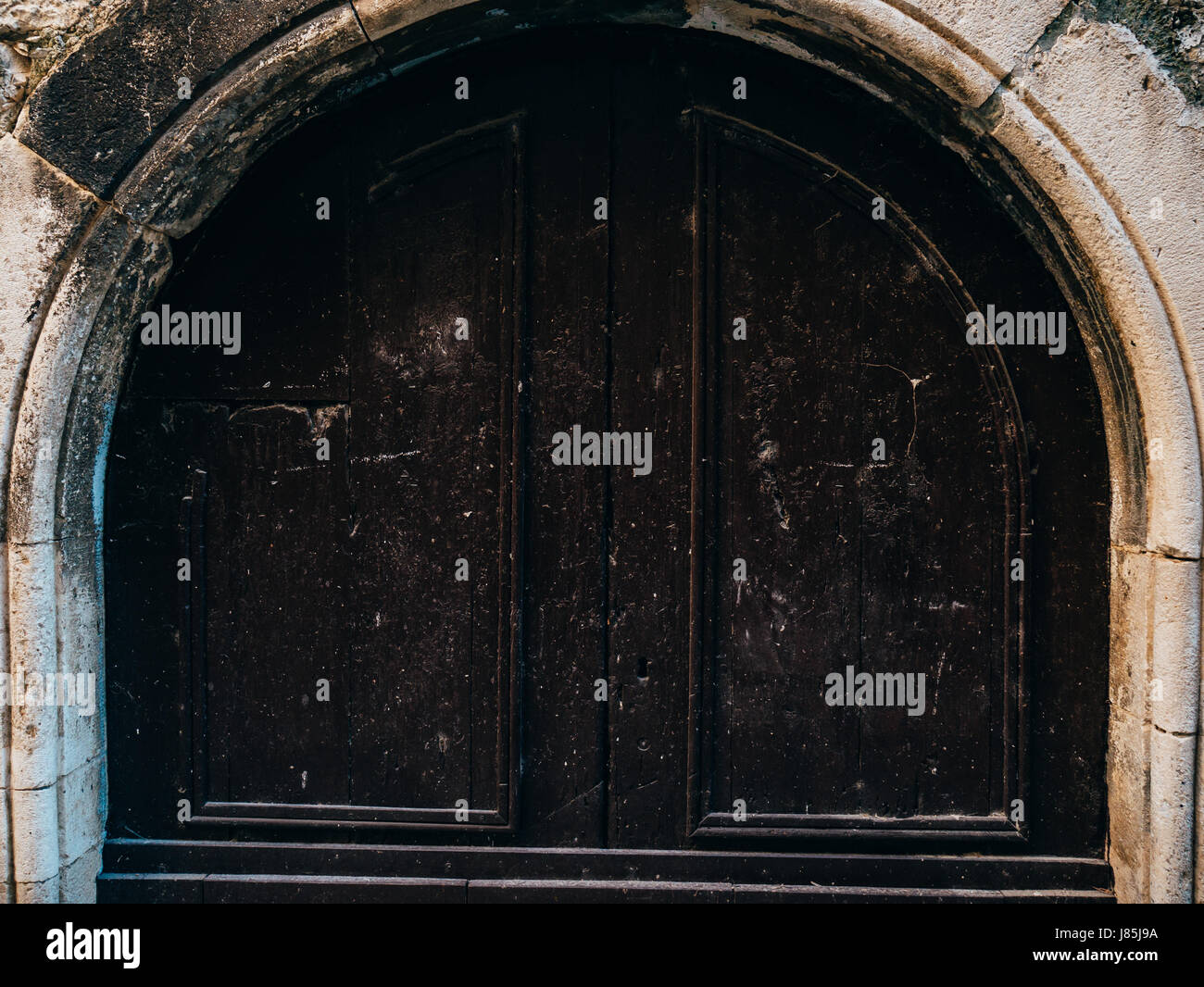 Old black doors. Wood texture. Texture of metal. Old shabby, irradiated ...