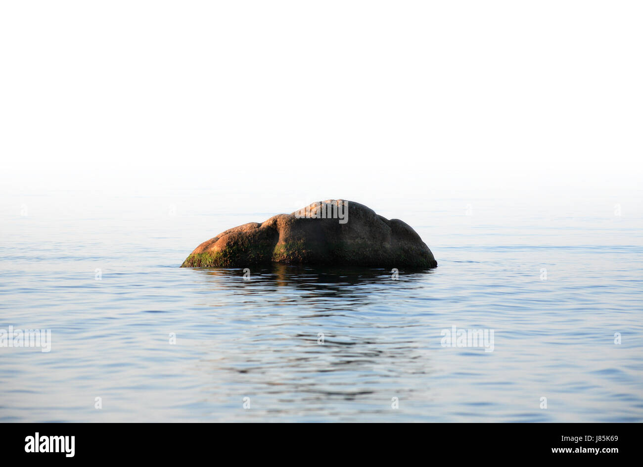 One big stone in tranquil sea under blank white space for text Stock ...