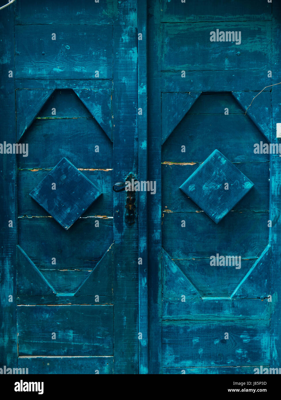 Old blue doors. Wood texture. Texture of metal. Old shabby, irradiated ...