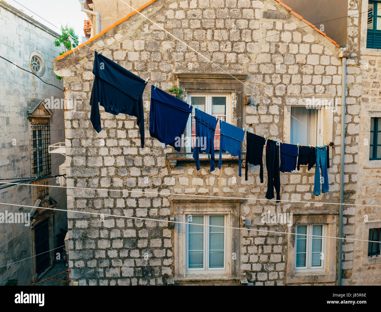 Clothes dries on ropes on clothespins. Drying clothes Stock Photo - Alamy
