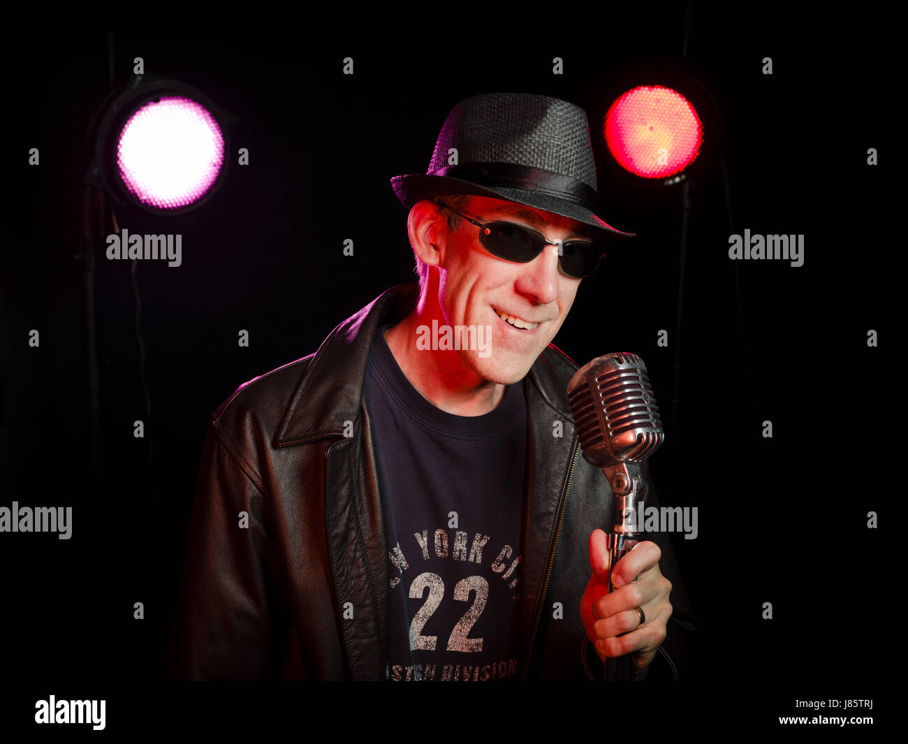 Stand-up comedian performing on stage with microphone Stock Photo - Alamy