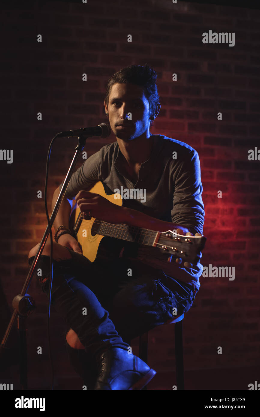 Portrait of confident male singer performing in nightclub Stock Photo ...