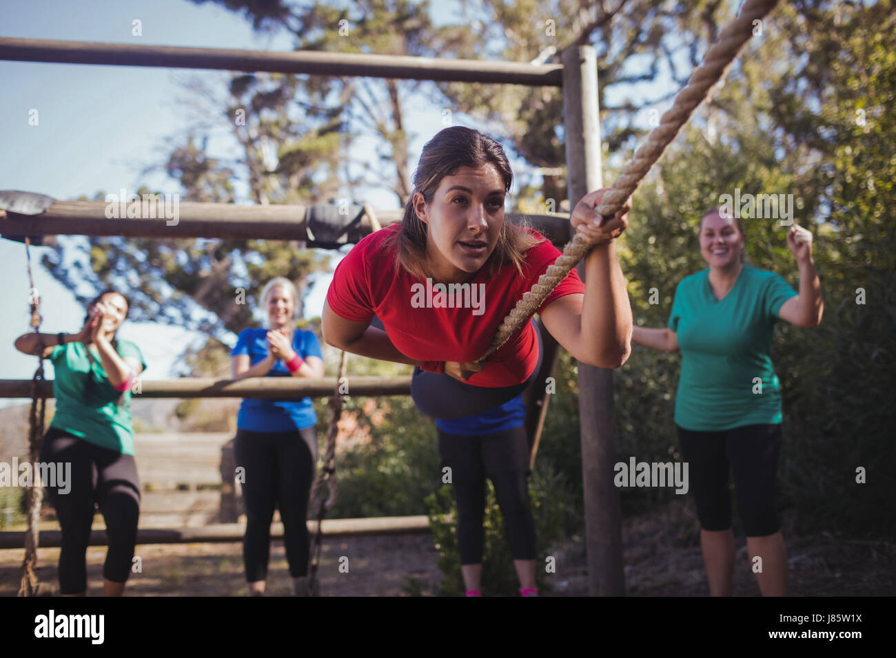 Man climbing rope during obstacle hi-res stock photography and images ...