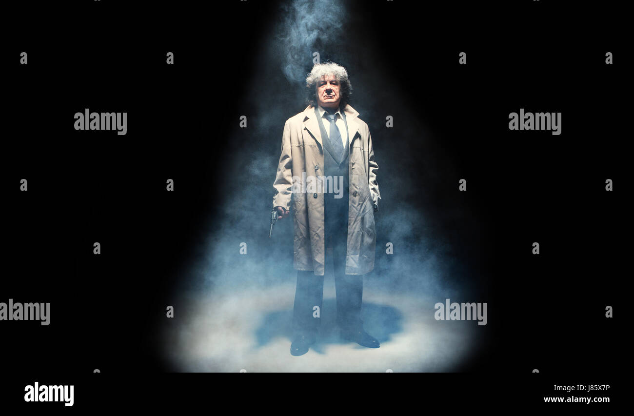Senior police agent with a gun on dark smoke background Stock Photo - Alamy