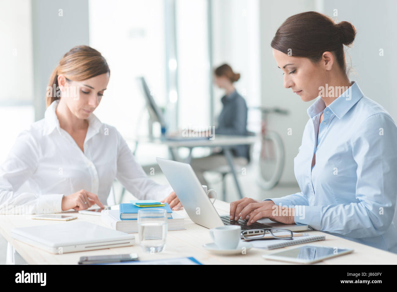 Successful confident business women working at office desk, efficiency ...