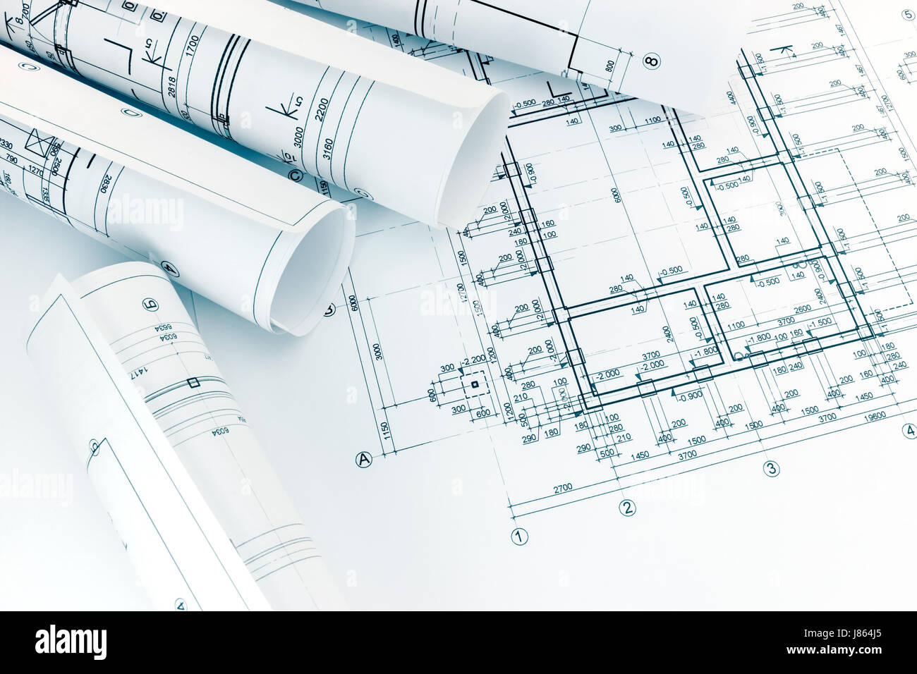 rolls of architecture blueprints with floor plan drawing on architects ...