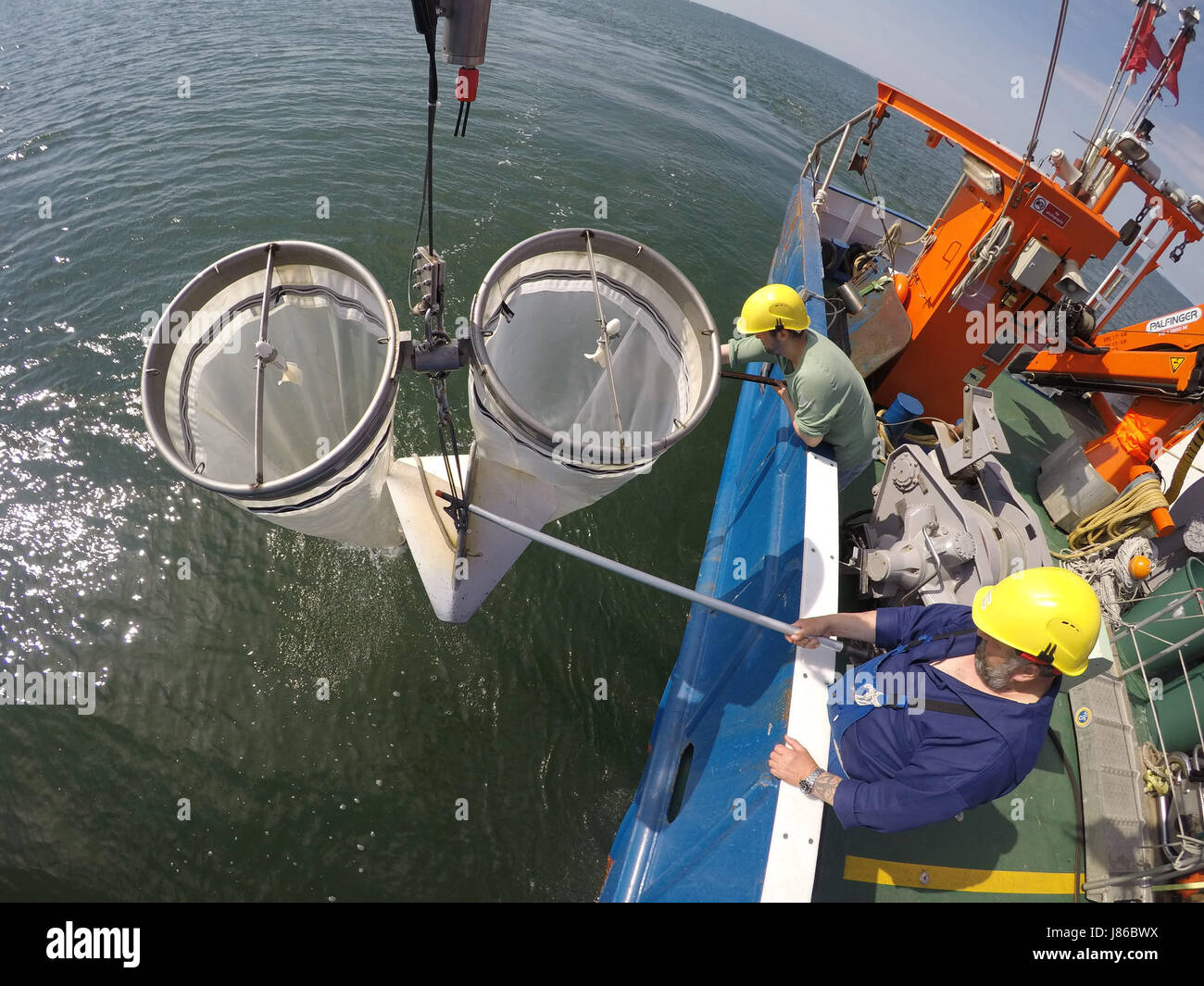 Boatman Gerald Schmidt and biology student Gai Fox (L-R) pull a finely ...
