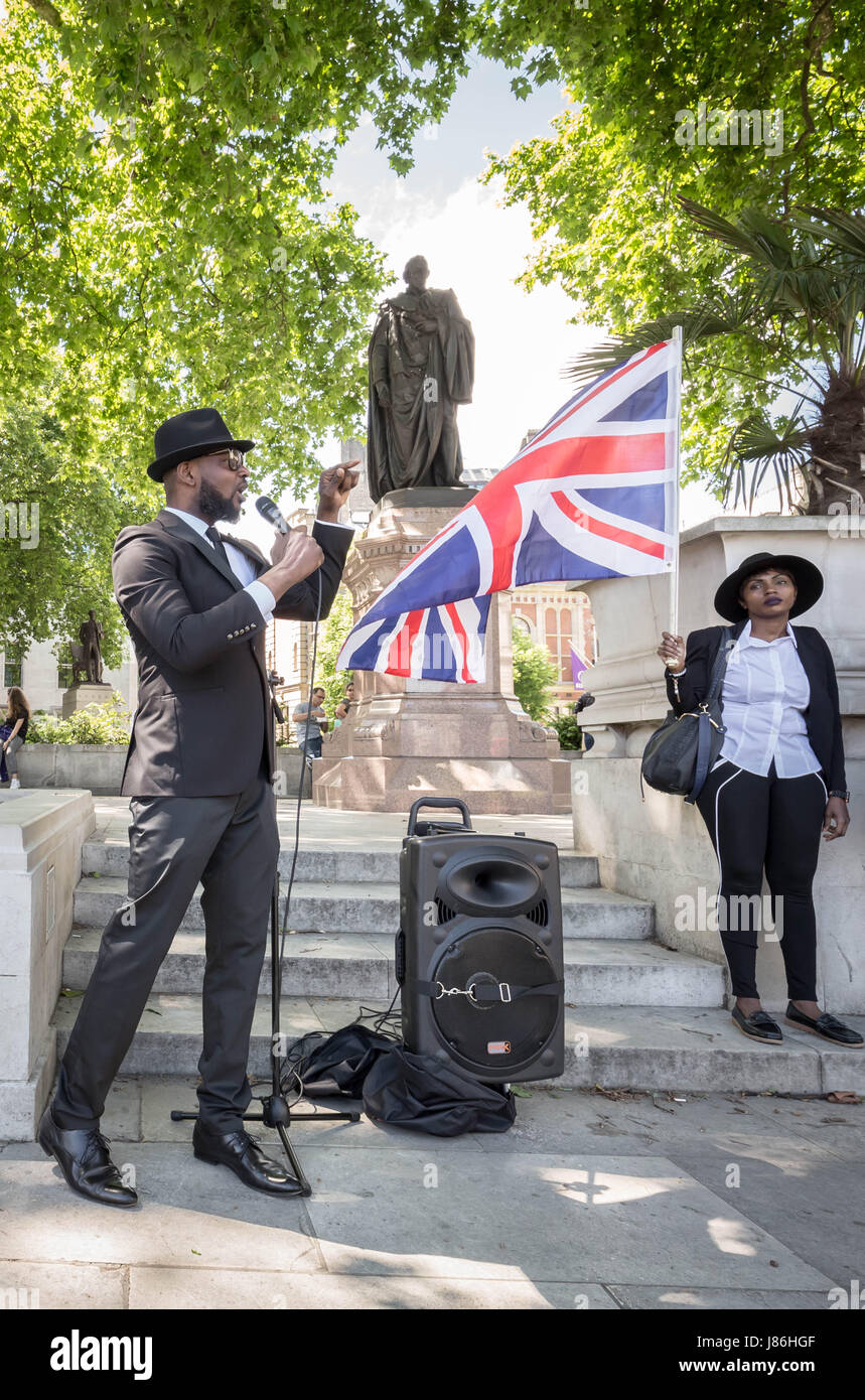 An Evangelical Christian street preacher and his followers speak in ...