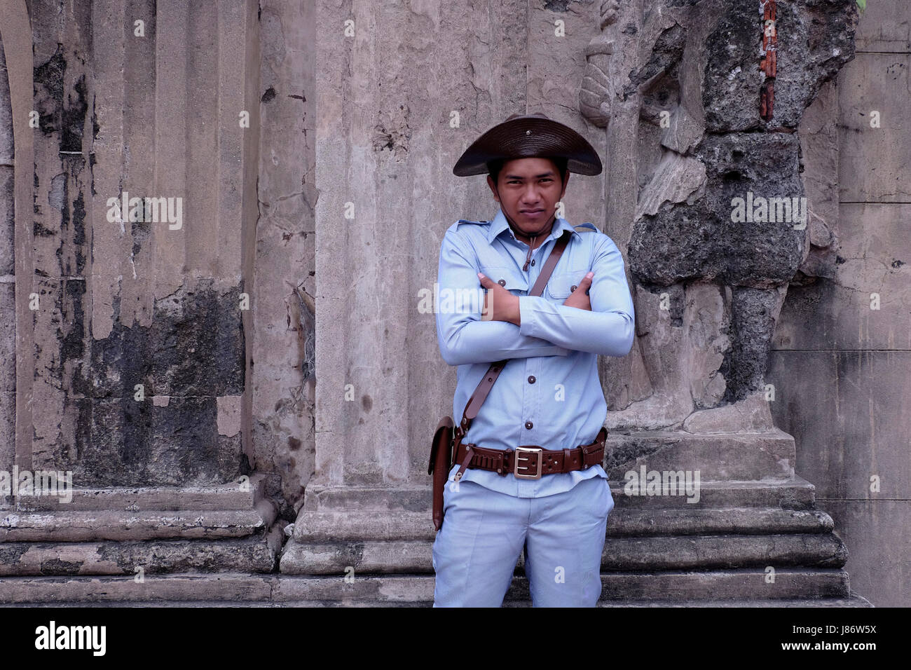 A Filipino guard dressed as a soldier from the Spanish colonial period ...
