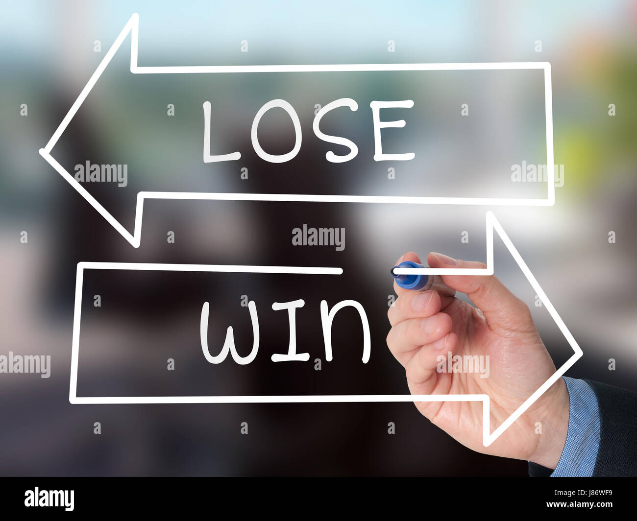 Man Hand drawing Win or Lose concept with white marker on visual screen ...