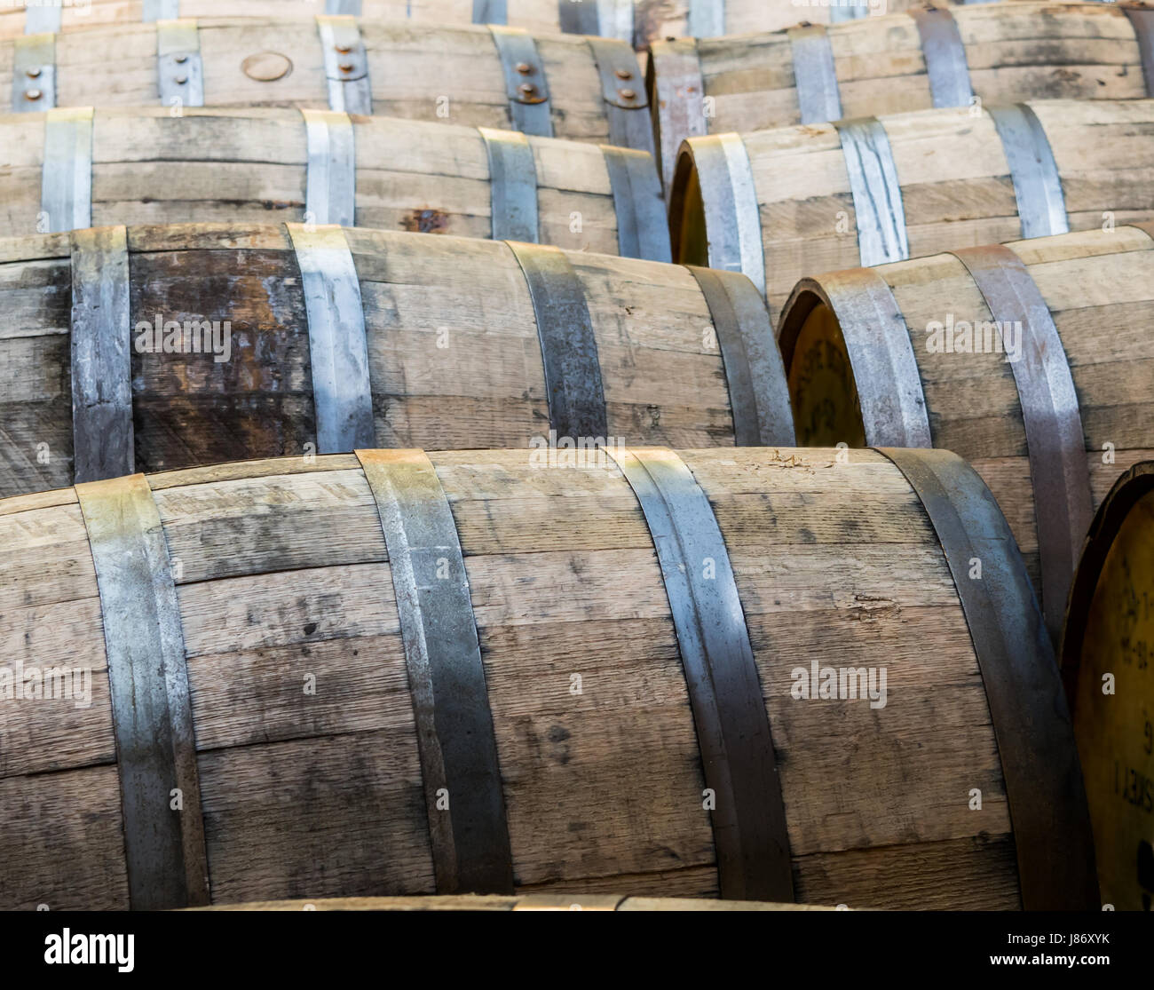 Rows of Old Bourbon Barrels rolling on their sides Stock Photo - Alamy