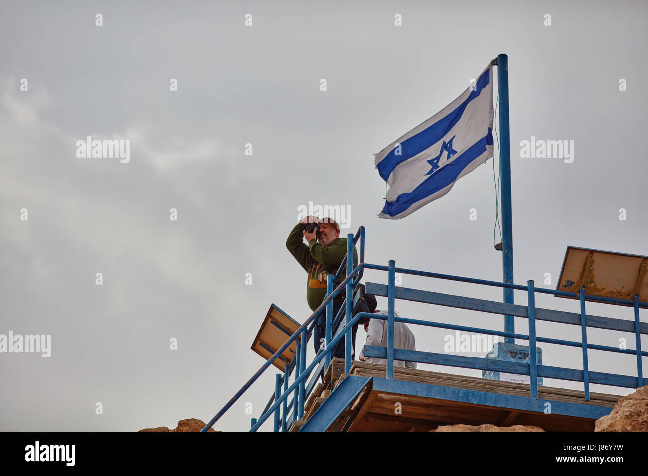 Photographer near Israeli flag in the Negev desert, Israel Stock Photo ...