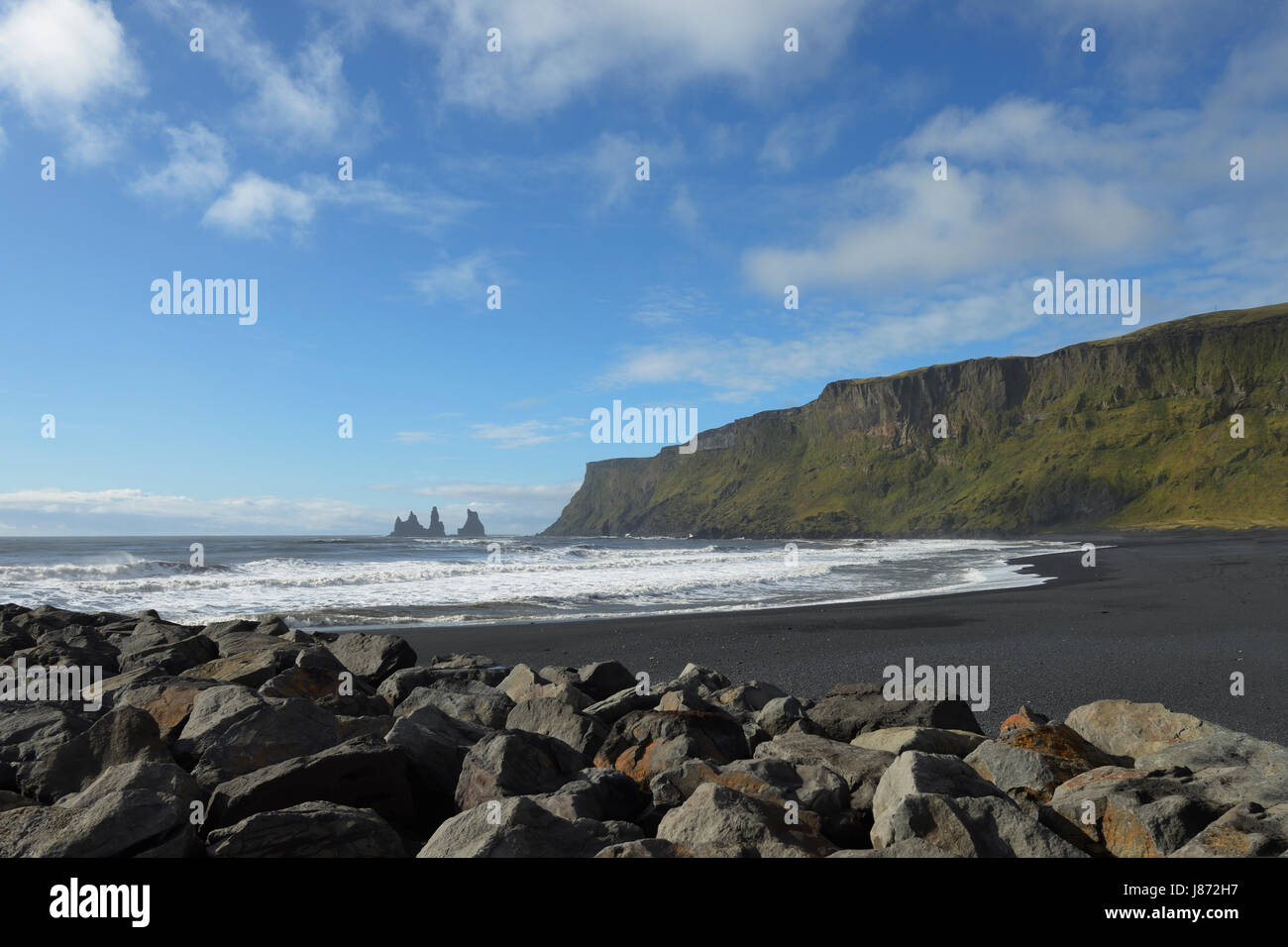 Black Lava Beach with Basalt Stacks of Reynisdrangar in the background ...