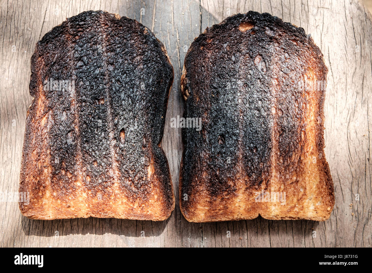 Crispy and Crunchy Over Burned Toasts place outdoor on wooden stool in ...