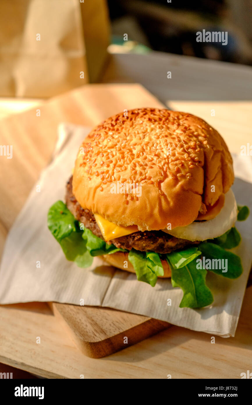 Yummy Beef and cheese Hamburger place with napkin on wood tray Stock ...