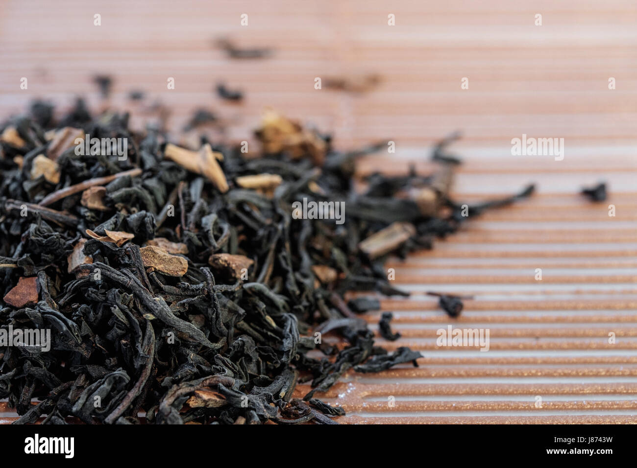 Heap of Dry tea leaves spread on light brown color background Stock ...