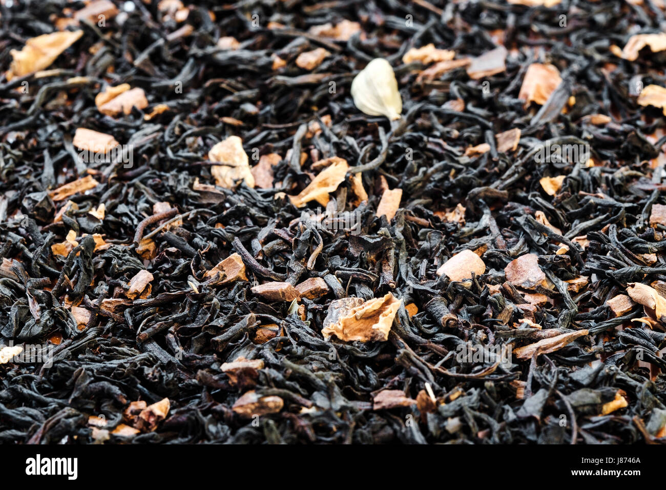 Heap of Dry tea leaves spread on light brown color background Stock ...