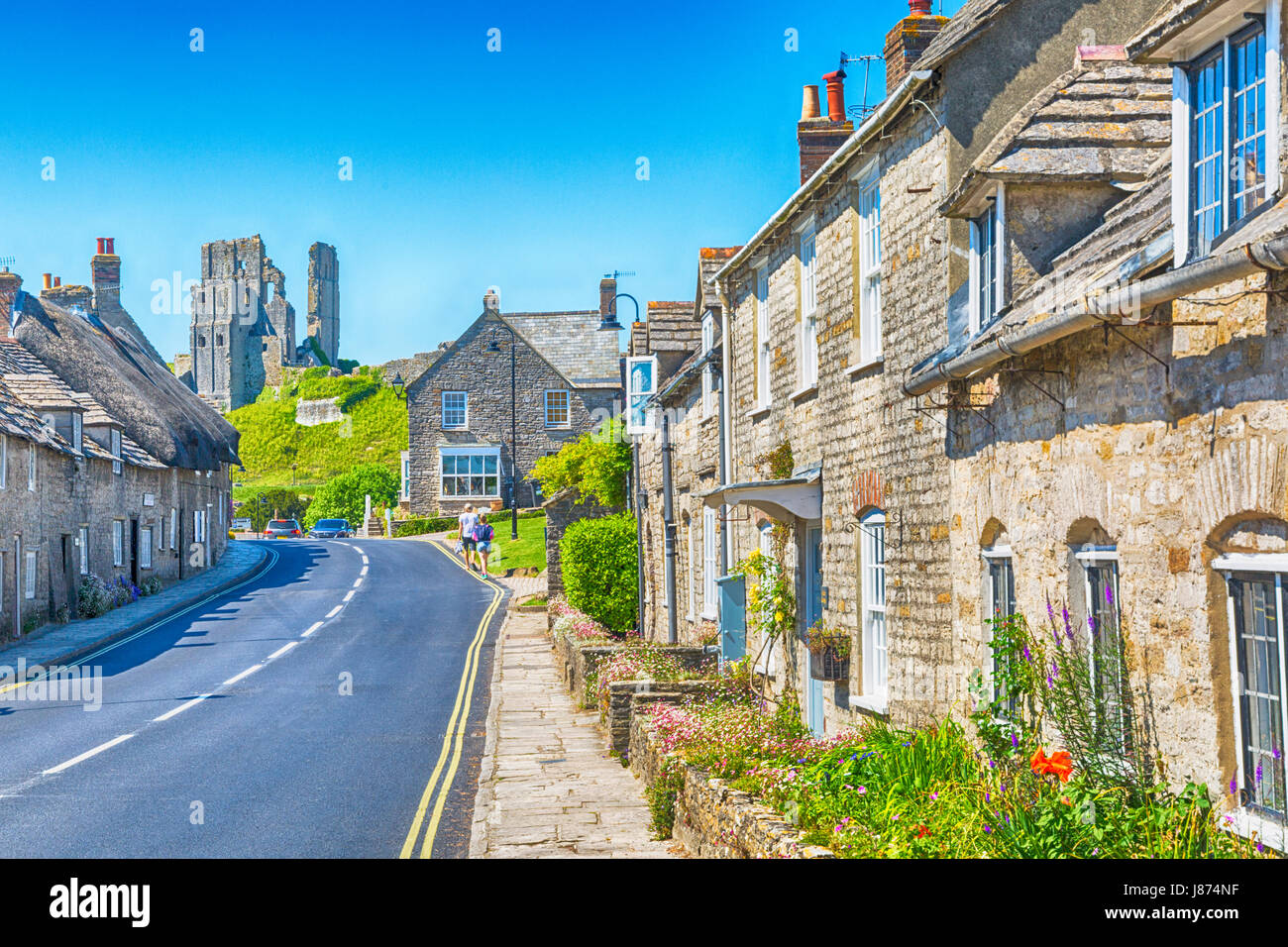 Road through Corfe Castle village with view of the castle at Corfe ...