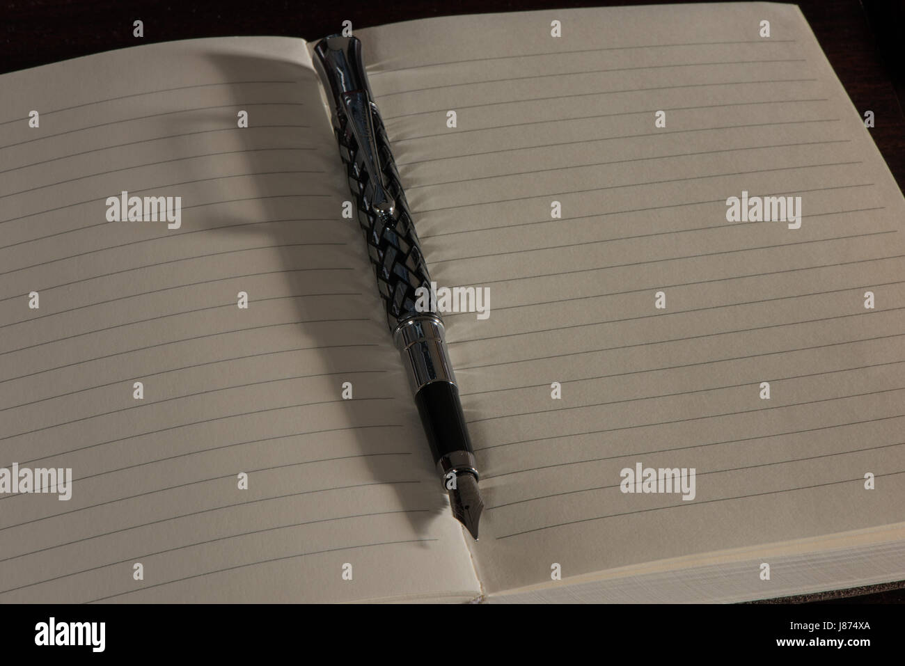 Still life close-up of pen and notebook in sepia Stock Photo - Alamy