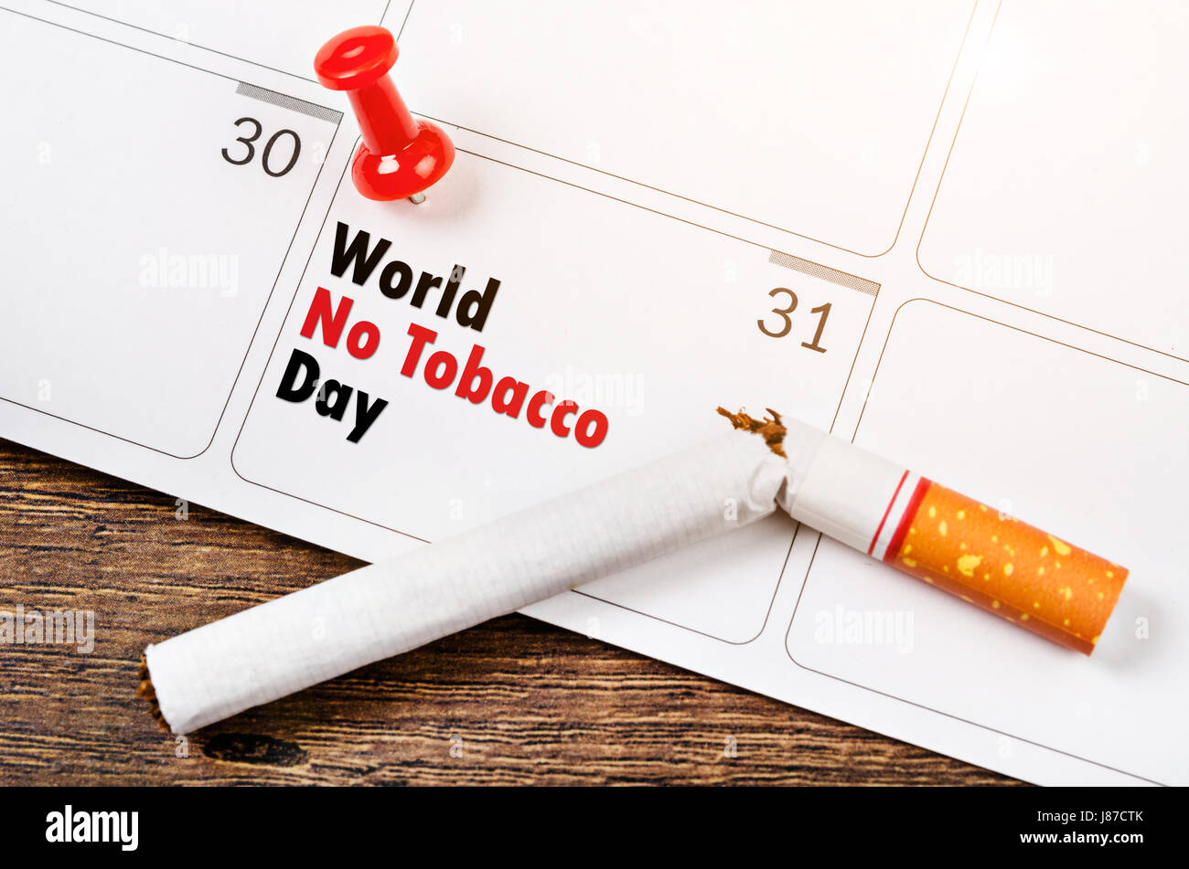 Push pins marked date Quit Smoking on calendar 31th May with tobacco ...