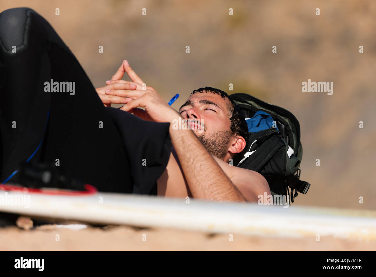 surfer sleeping next to his board Stock Photo - Alamy