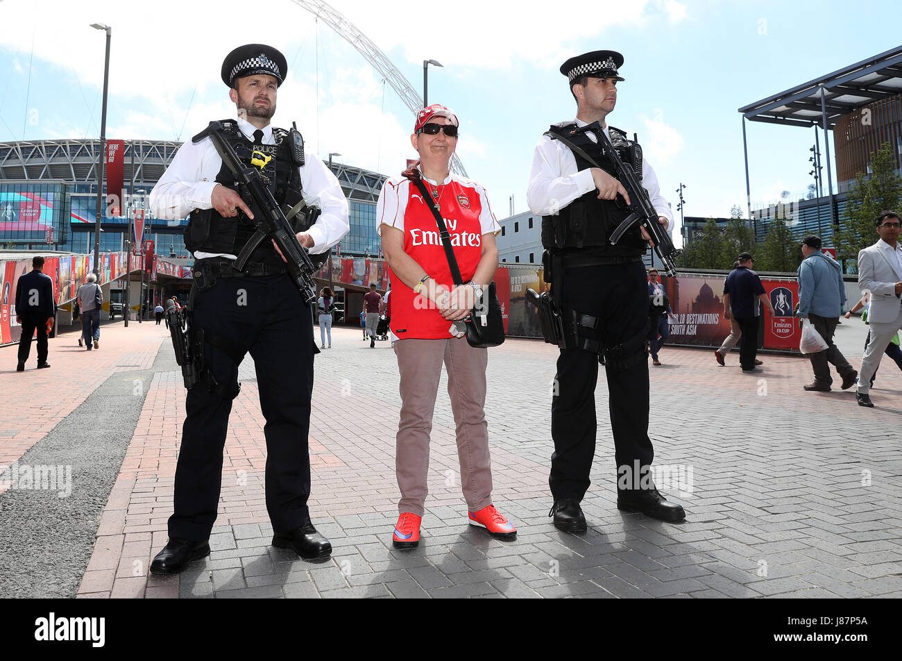A fan poses for a picture with the police out the stadium before the ...